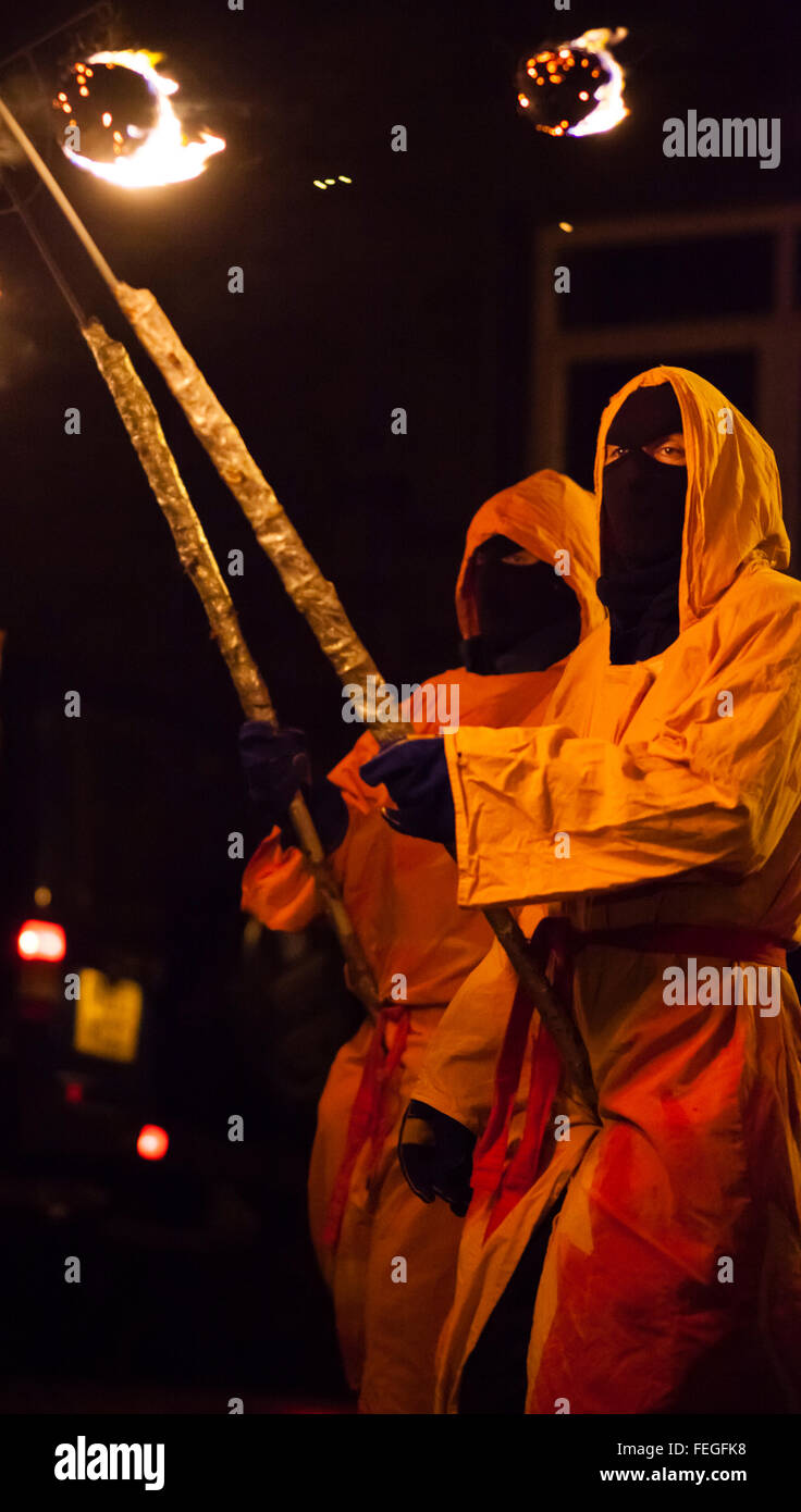 Masked figures lead a torchlight procession for the Imbolc Fire ...