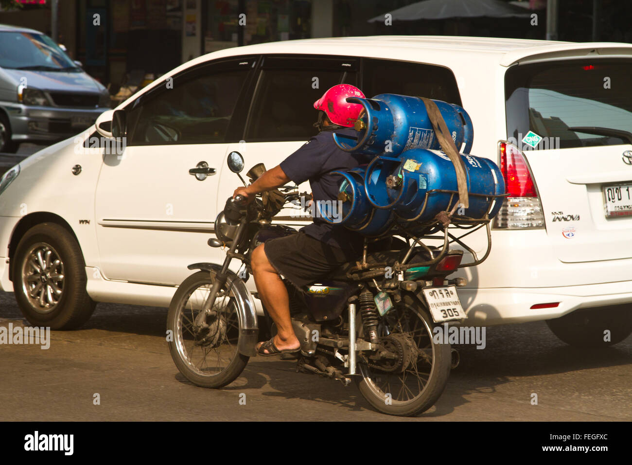 Man transporting LPG gas on a motorcycle Stock Photo - Alamy