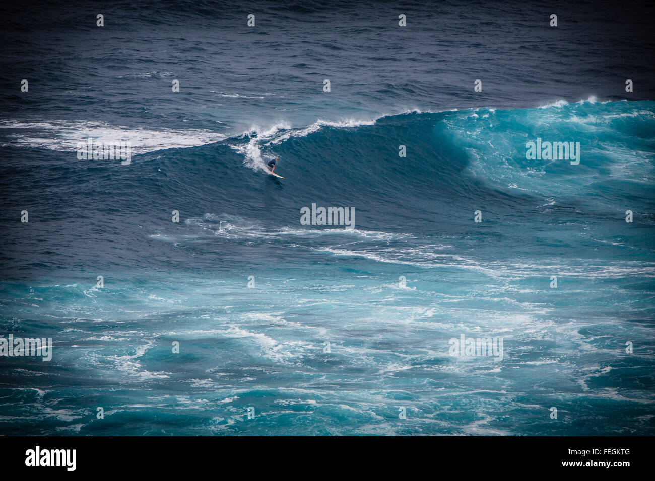 A surfer is riding a huge wave at Peahi (Jaws) on the island of Maui ...