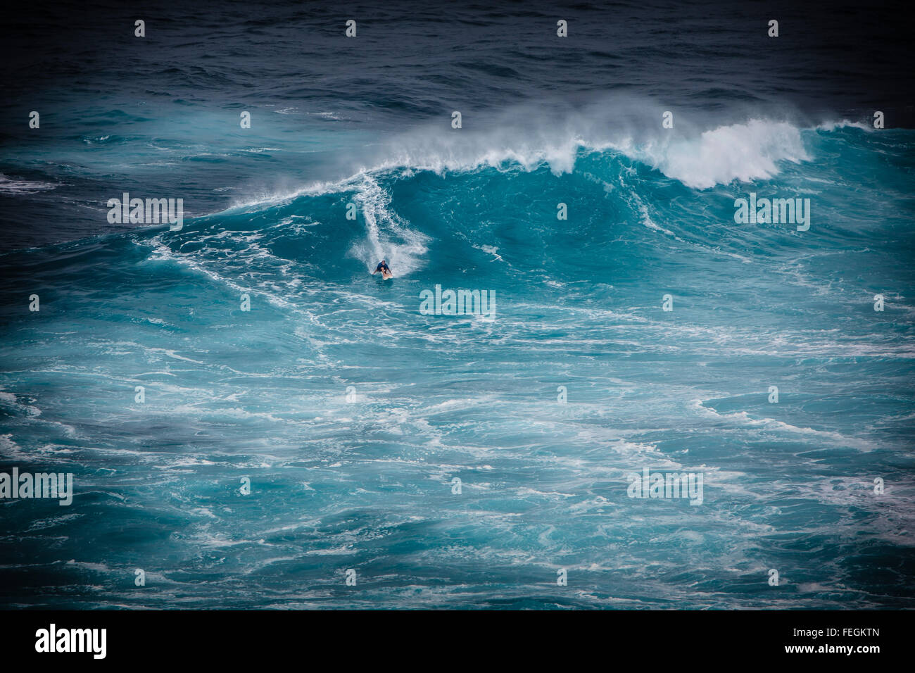 A surfer is riding a huge wave at Peahi (Jaws) on the island of Maui ...