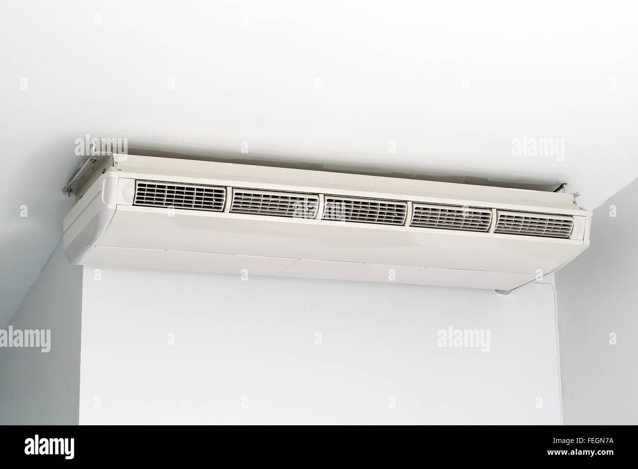 Air Conditioning hung on the ceiling in the white room Stock Photo - Alamy
