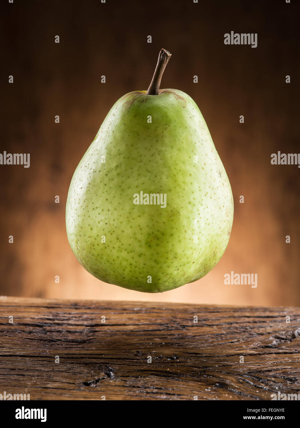 Pear is in the air under the wooden table Stock Photo - Alamy