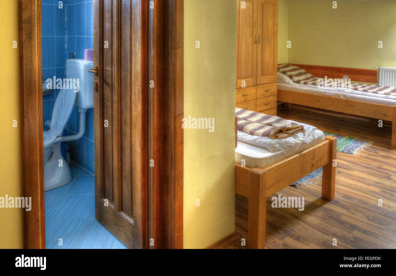 Interior of a hostel room with a blue bathroom Stock Photo - Alamy