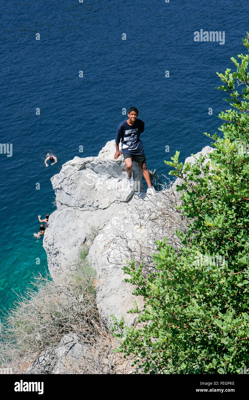 Boy on the rocks in Gümüşlük mezarlıkları island in Turkey Stock Photo ...