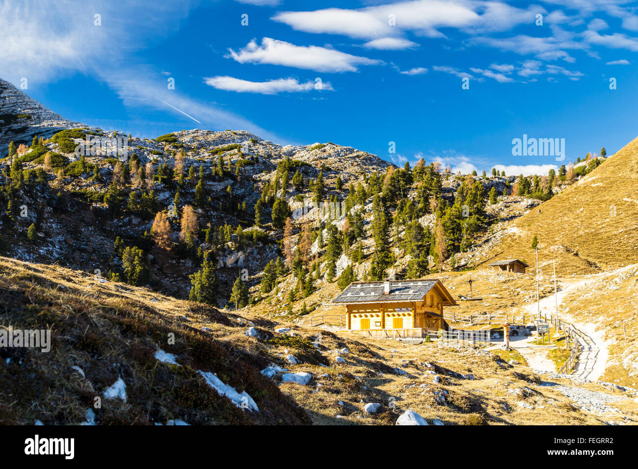 Alpine hut with a bench in the italian alps Stock Photo - Alamy