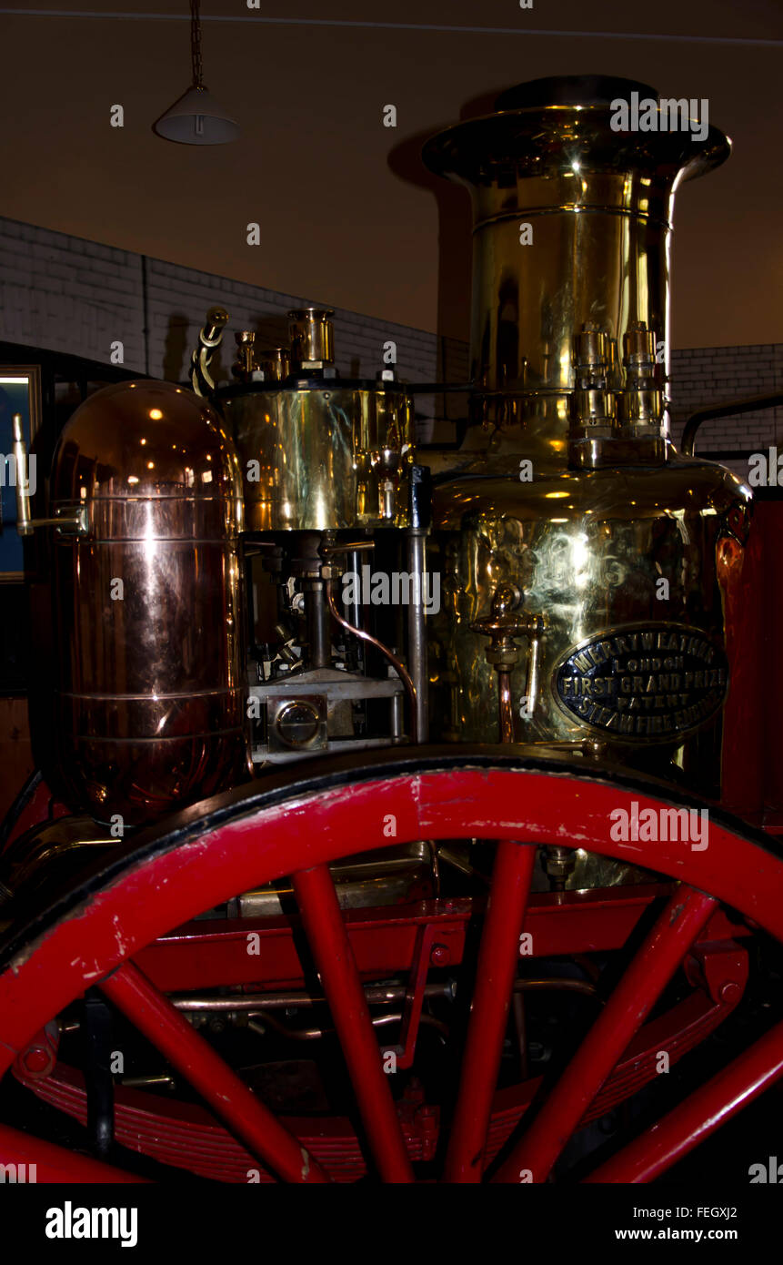 Steam-powered water pump mounted on a vintage hand-propelled fire ...