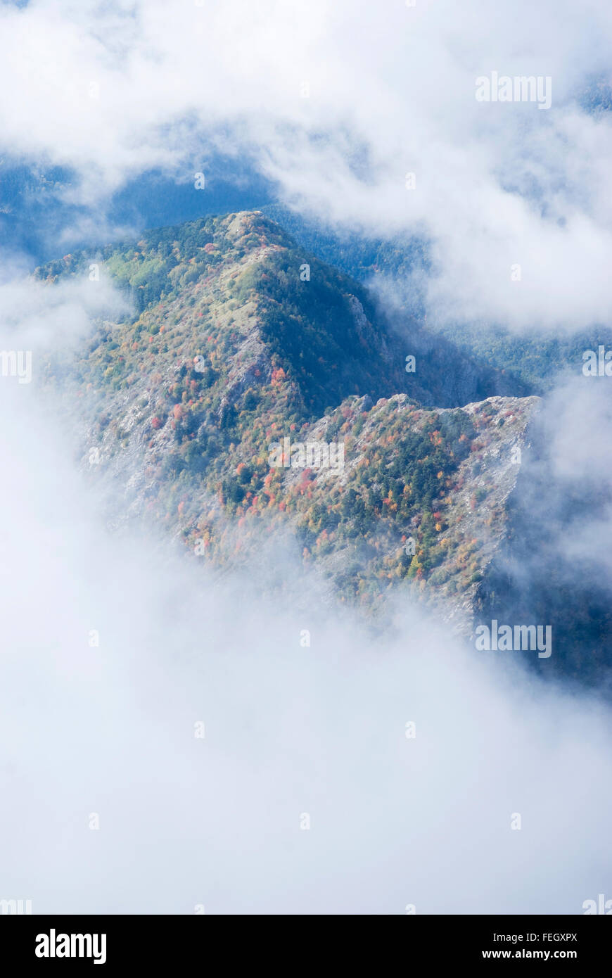 Italian Alps. Fog revealing the mountain range Stock Photo - Alamy