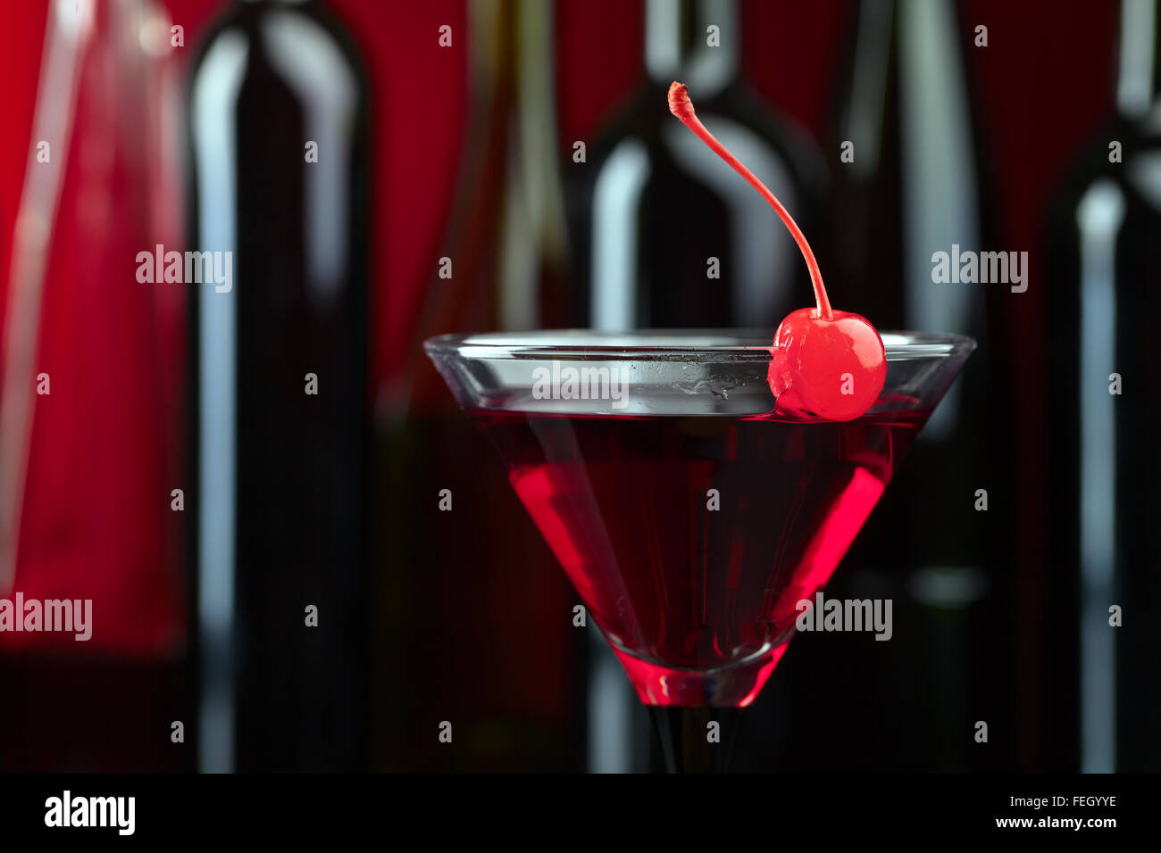 Cocktail with cherry on black table in bar Stock Photo - Alamy