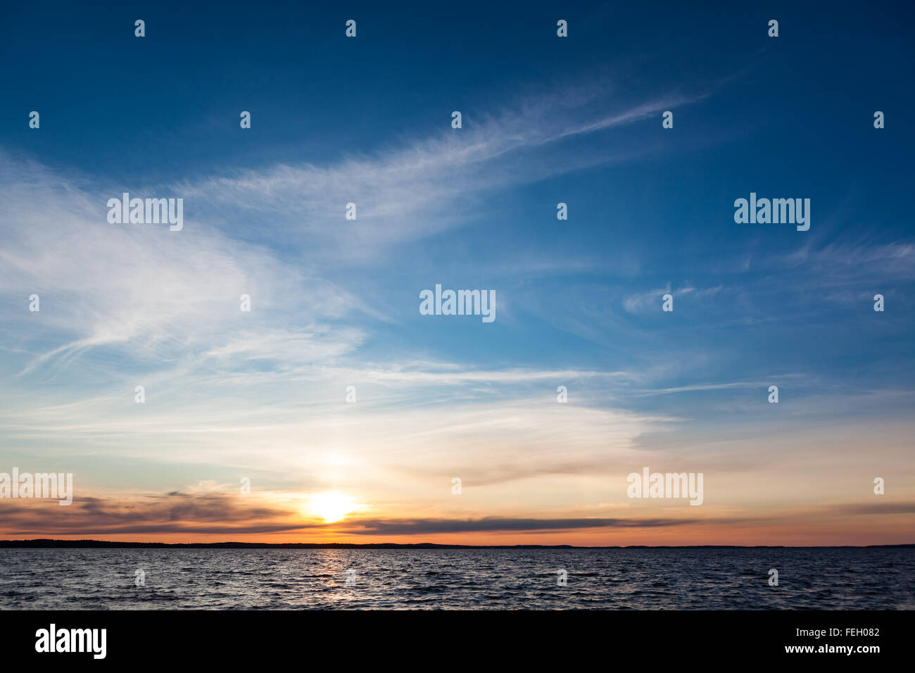 Calm sunset and clouds over lake Stock Photo - Alamy