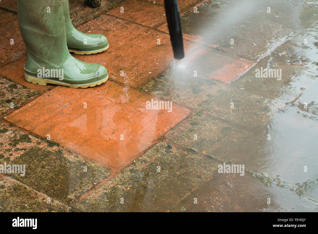 Power washing dirty patio Stock Photo - Alamy