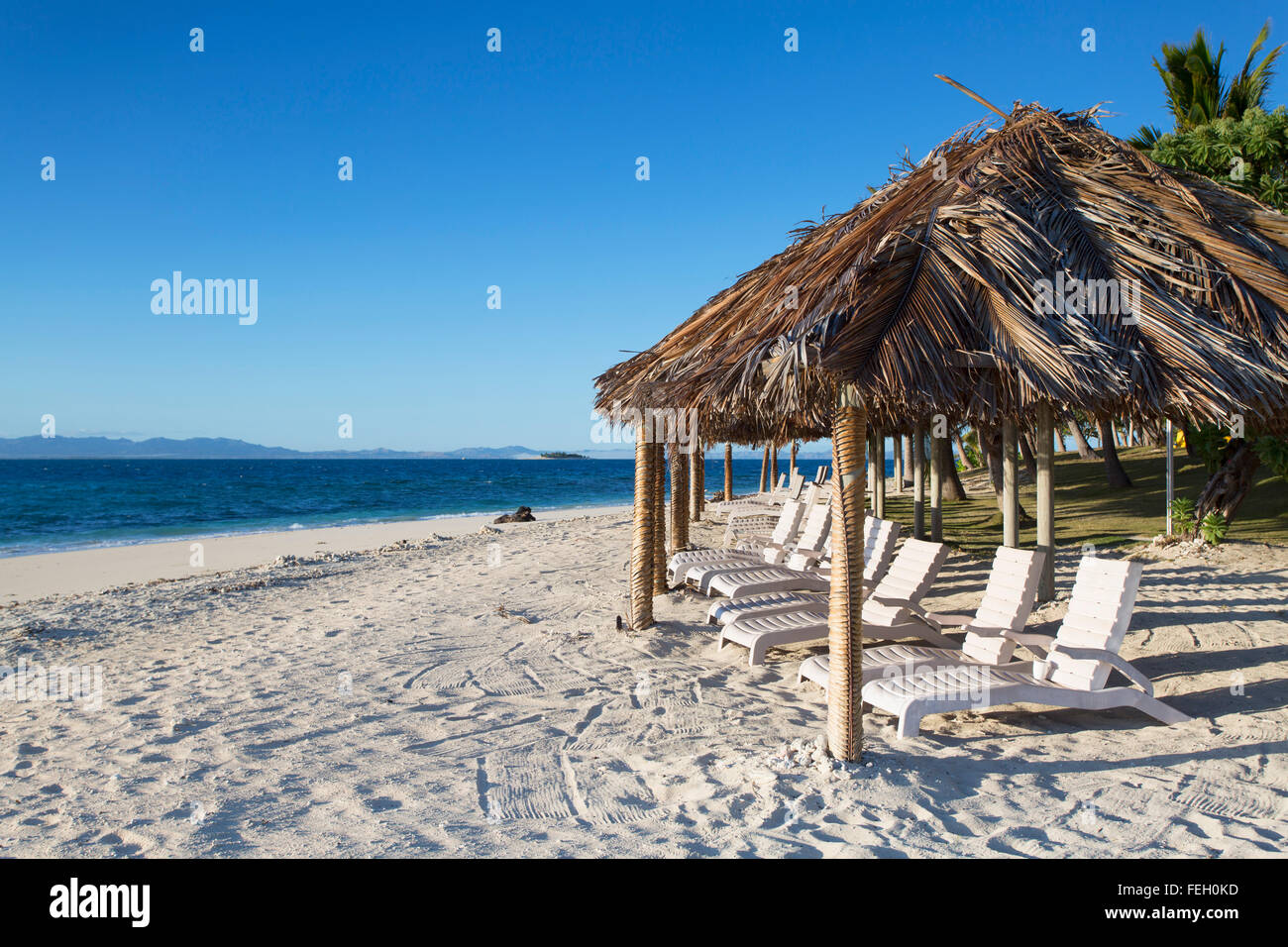 Sunloungers on beach at Bounty Island Resort on Bounty Island, Mamanuca ...