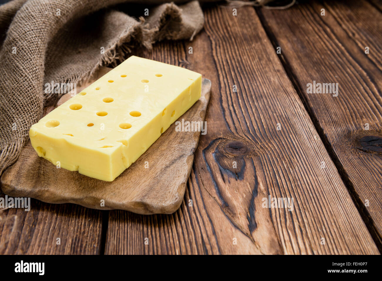 Diced Cheese (close-up shot) on rustic wooden background Stock Photo ...