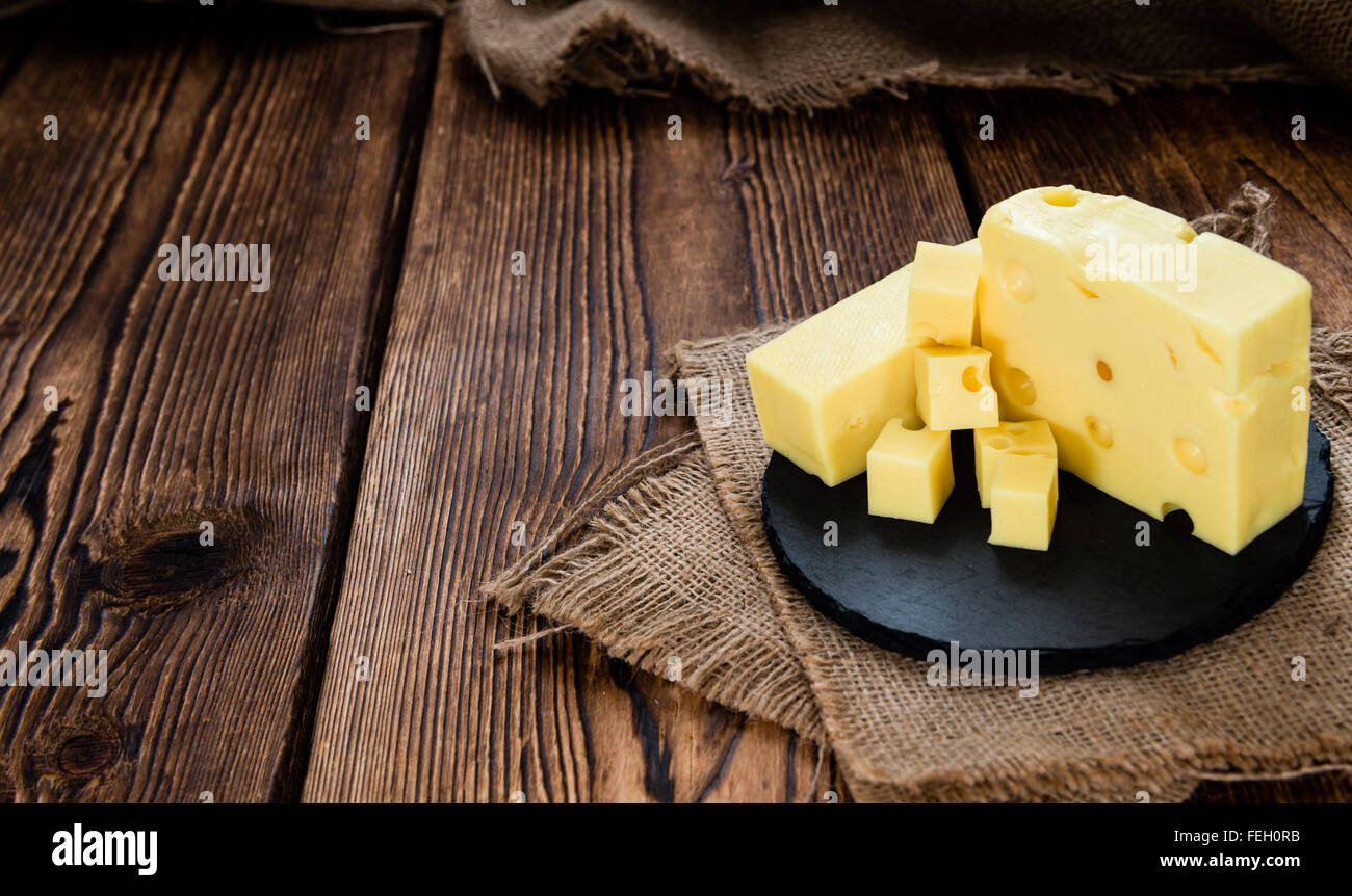 Block of Cheese (close-up shot) on vintage wooden background Stock ...