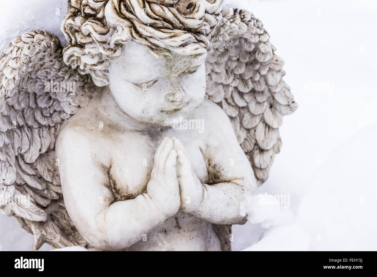stone sculpture of praying angelr Stock Photo - Alamy