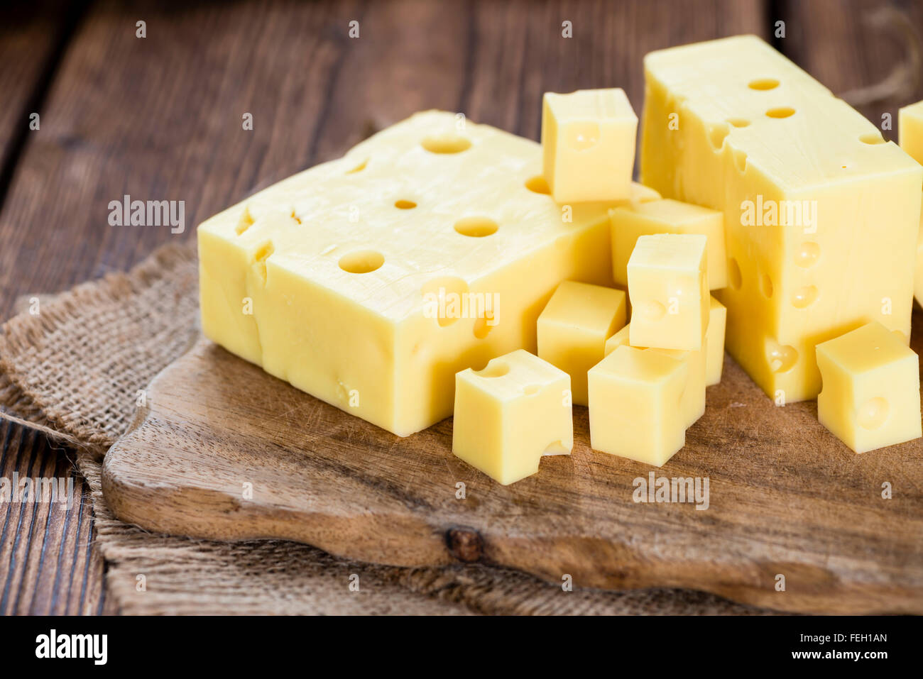 Portion of Cheese (close-up shot) on rustic wooden background Stock ...