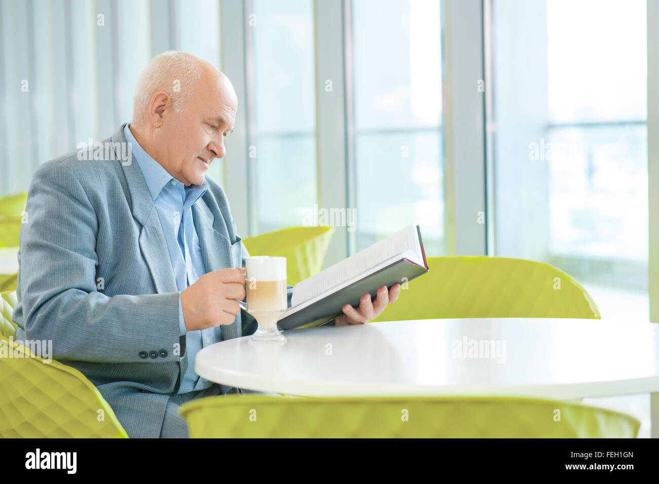Mature wise man reading a book Stock Photo - Alamy