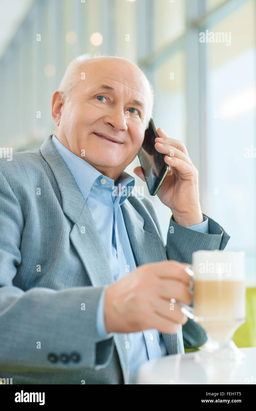 Old man making a call Stock Photo - Alamy