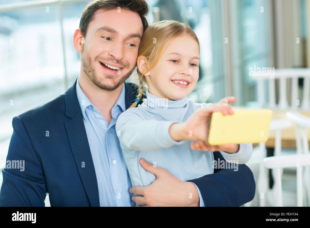 Smiling good-looking father with daughter posing for picture Stock ...