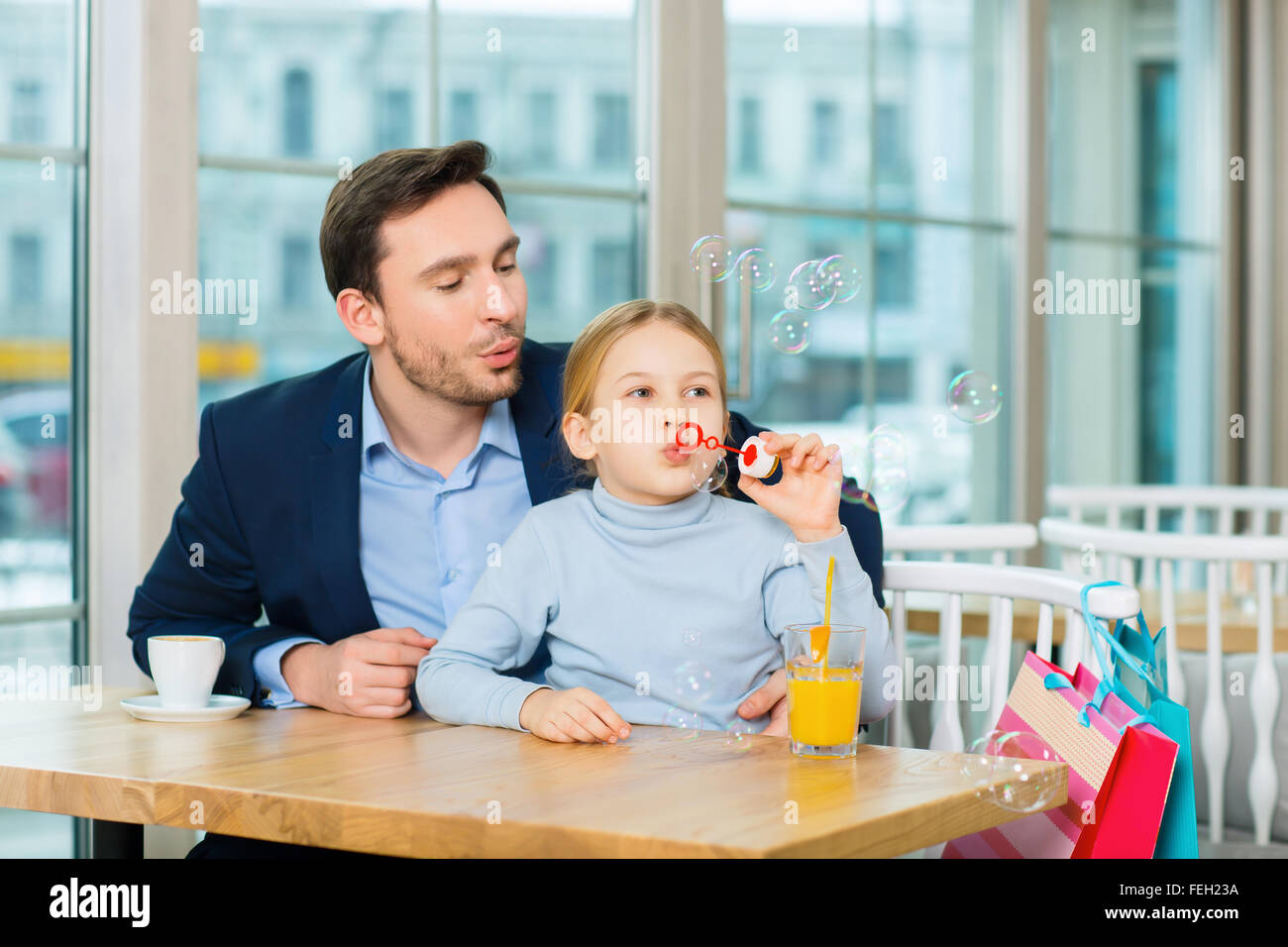 Happy blowing bubbles family Stock Photo - Alamy