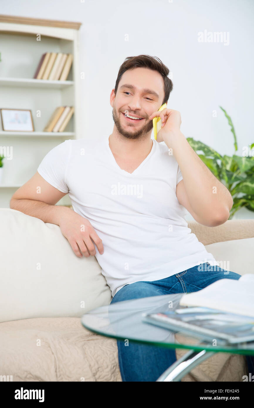 Smiling man enjoying conversation with a friend Stock Photo - Alamy