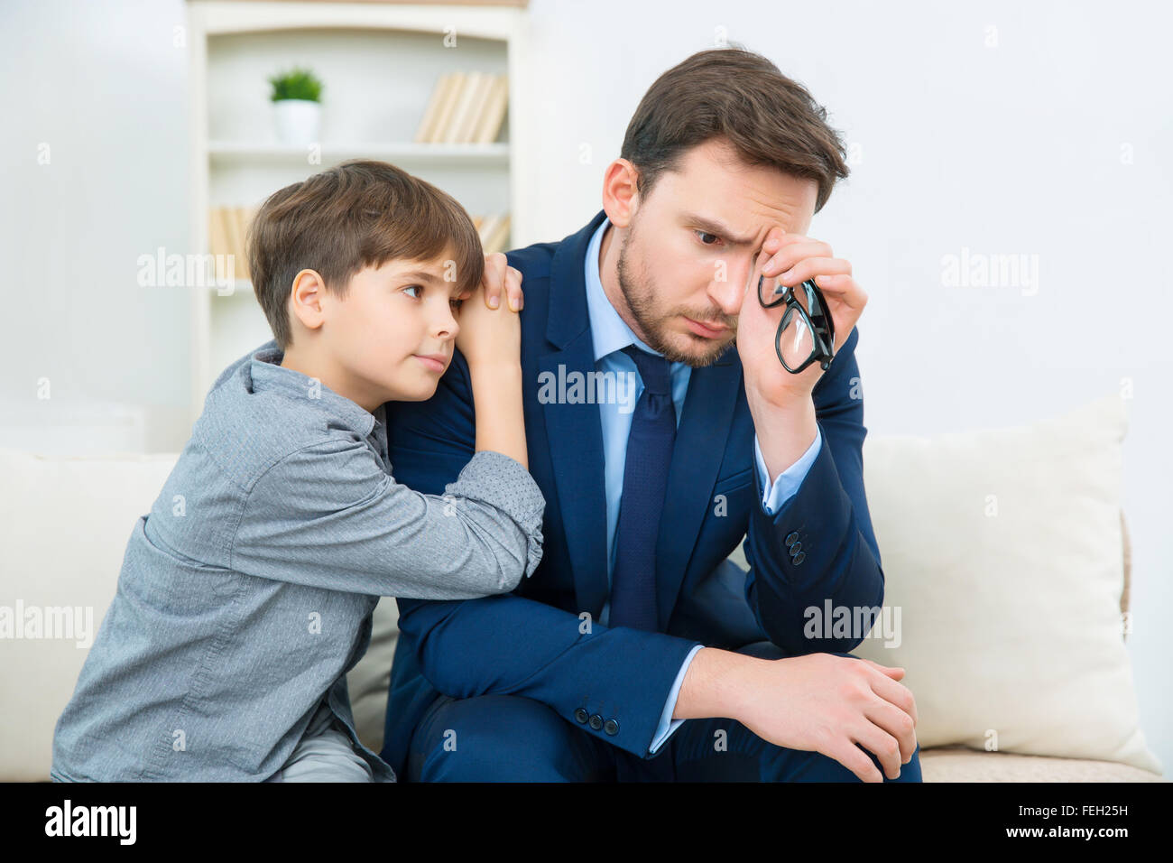 Father is feeling worry while son trying to comfort him Stock Photo - Alamy