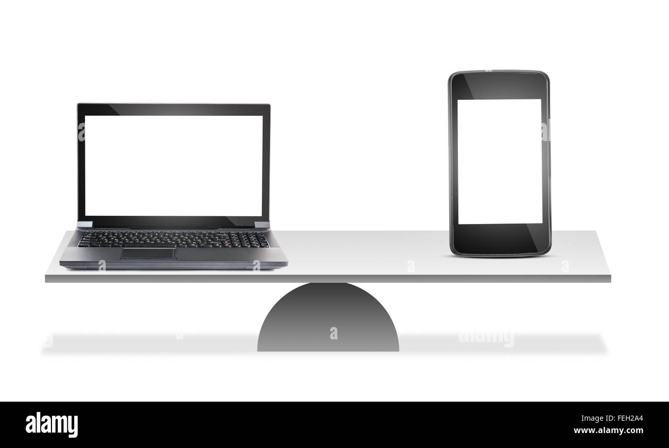 Laptop and smartphone on scales Stock Photo - Alamy