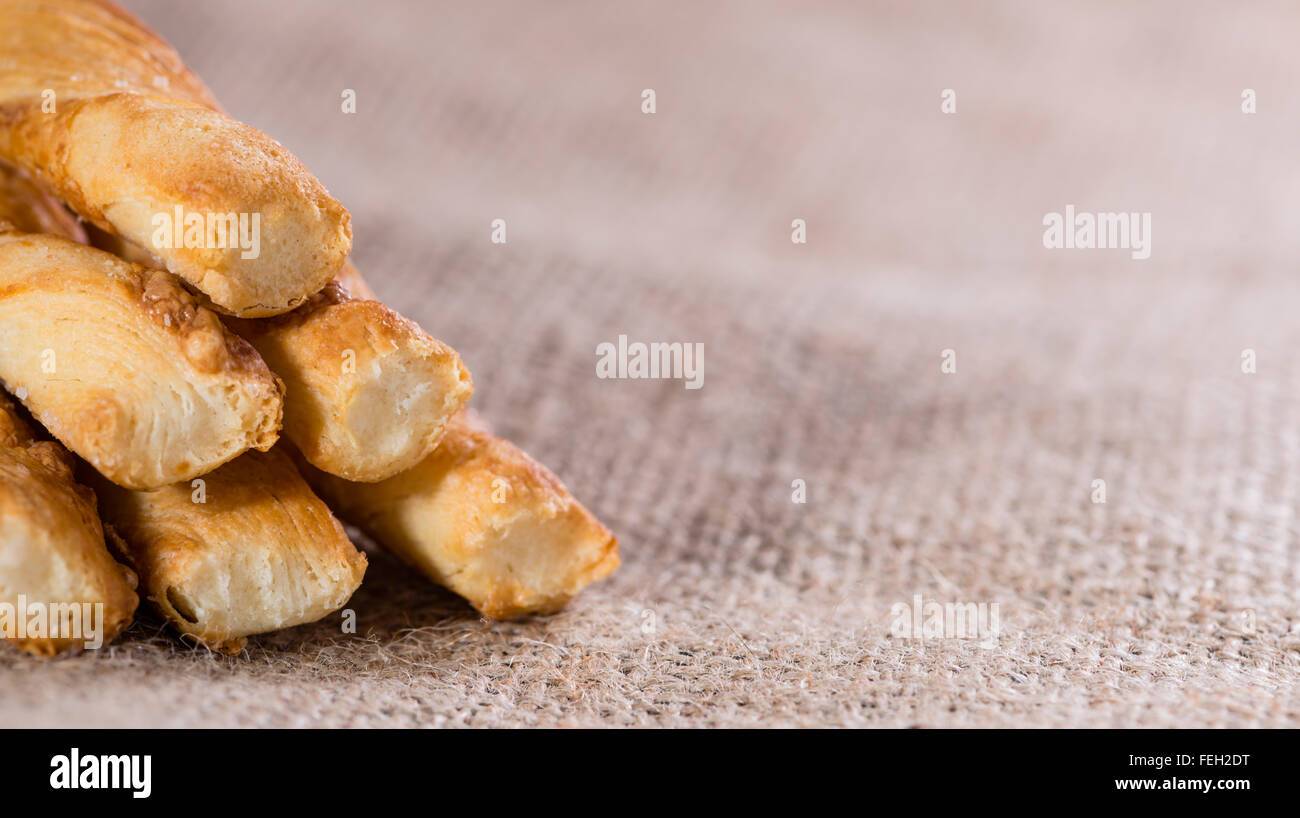 Crispy Pastry Sticks on wooden background (close up shot, selective ...