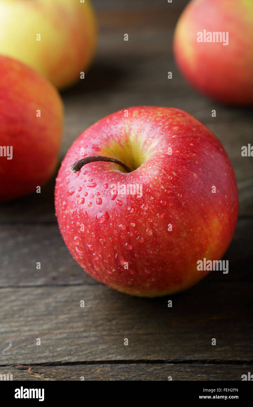 big red apple on old wooden background, food closeup Stock Photo - Alamy