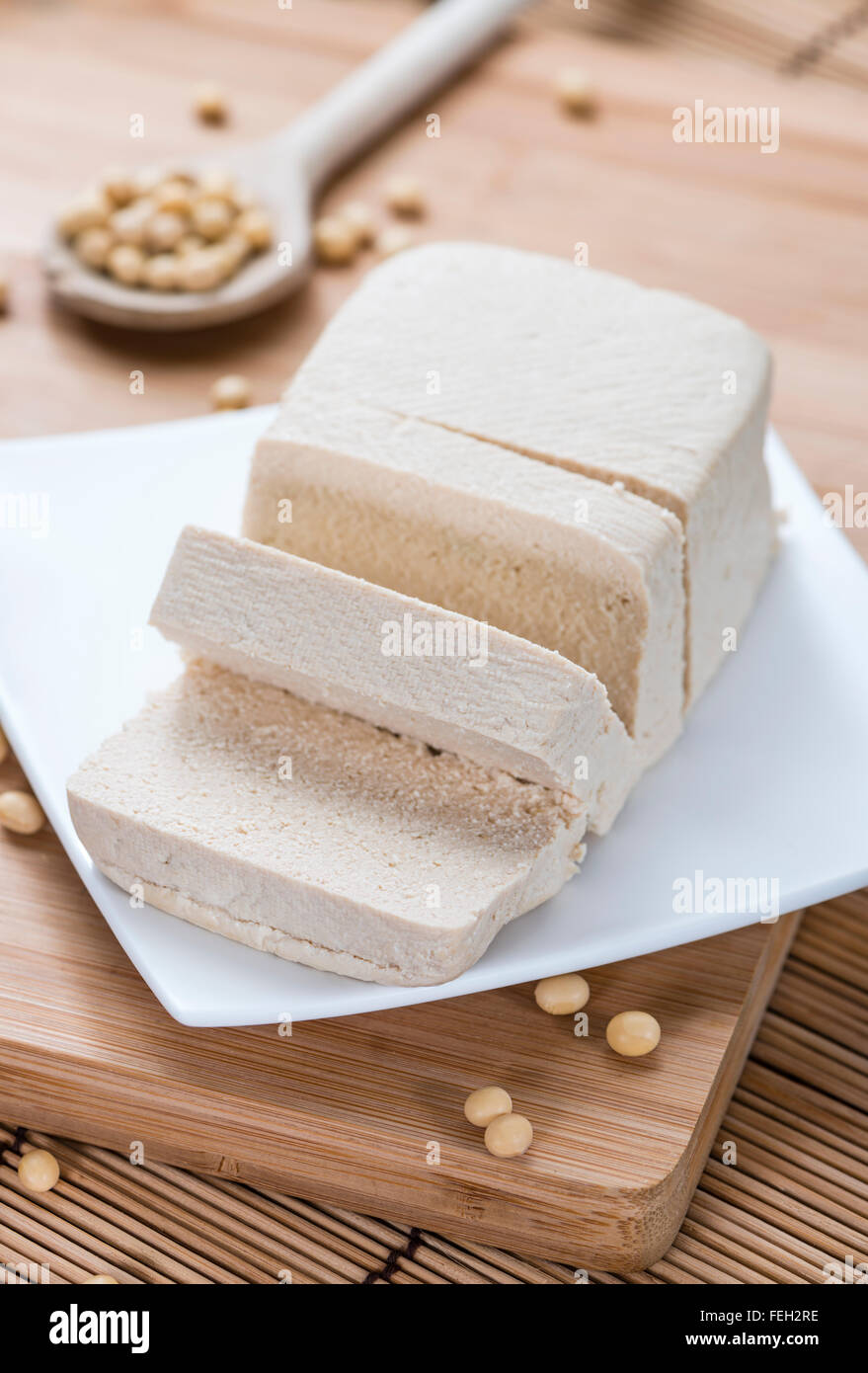 Portion of diced Tofu (detailed close-up shot) on wooden background ...