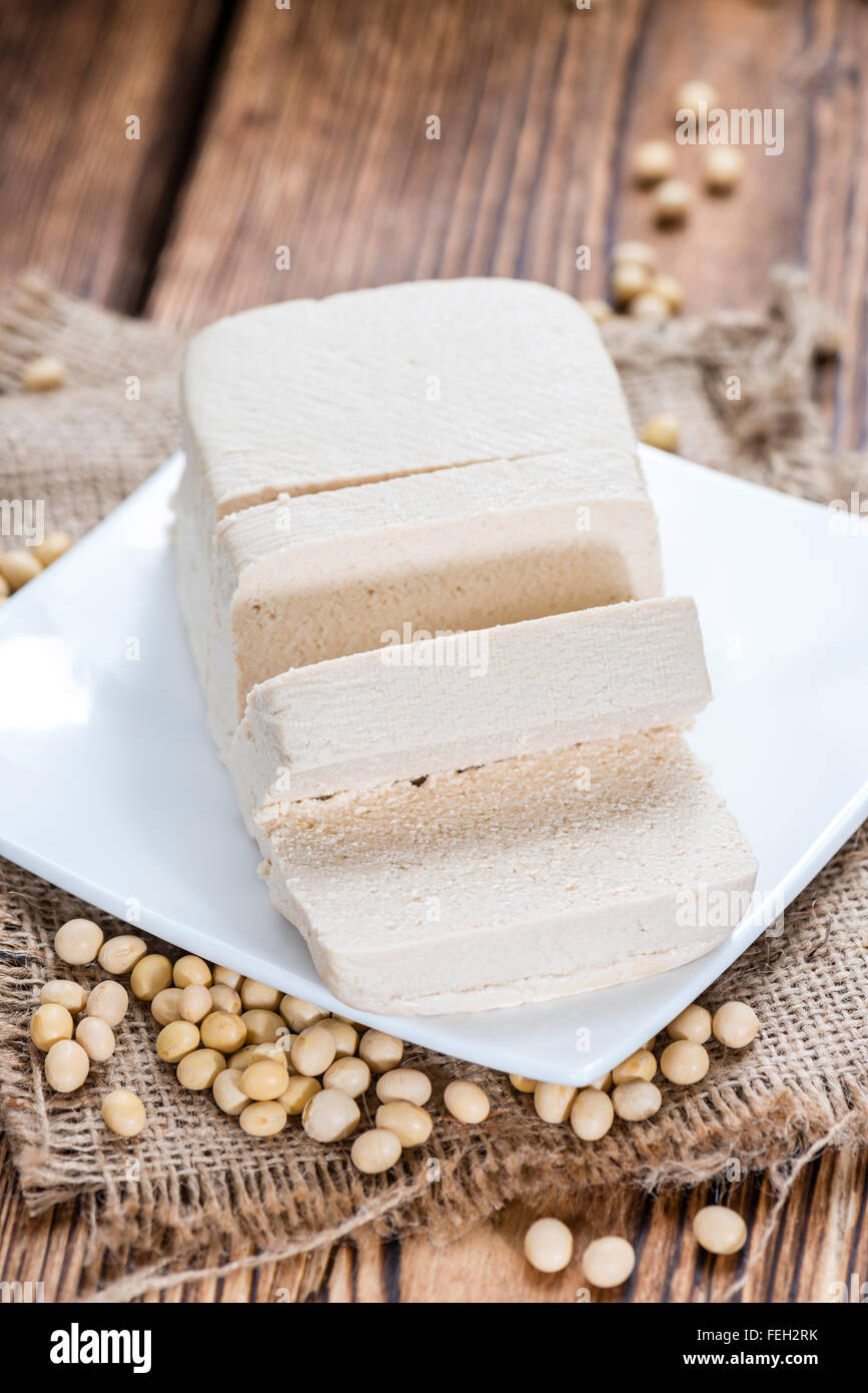 Portion of diced Tofu (detailed close-up shot) on wooden background ...