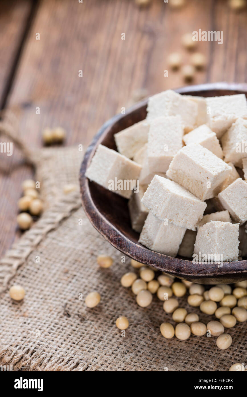 Portion of diced Tofu (detailed close-up shot) on wooden background ...