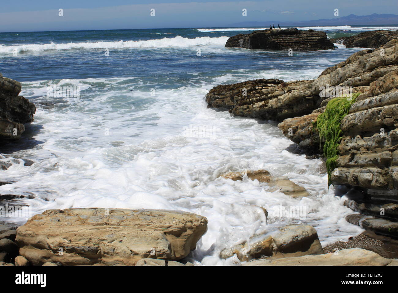 Waves crashing on the rocks . Rocks looking stepping stone going into ...