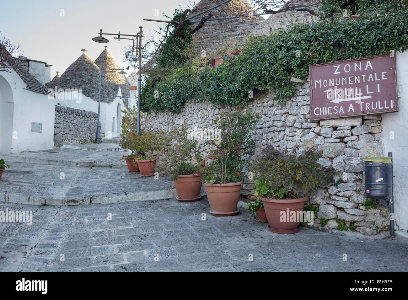 path in the trulli area of Rione Monti with a sign to the trullis and ...