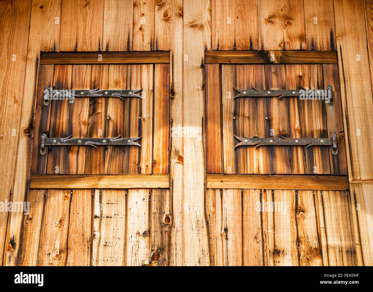 Rustic facade of a wooden house with wooden shutters. Typical facade ...
