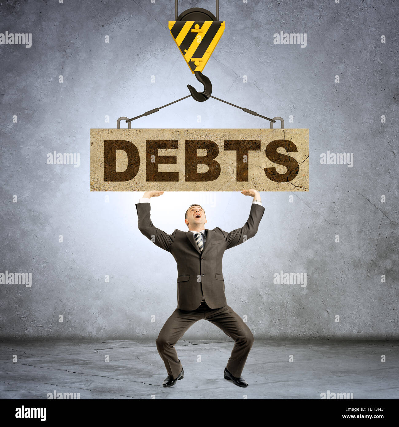Businessman holding heavy word debts Stock Photo - Alamy