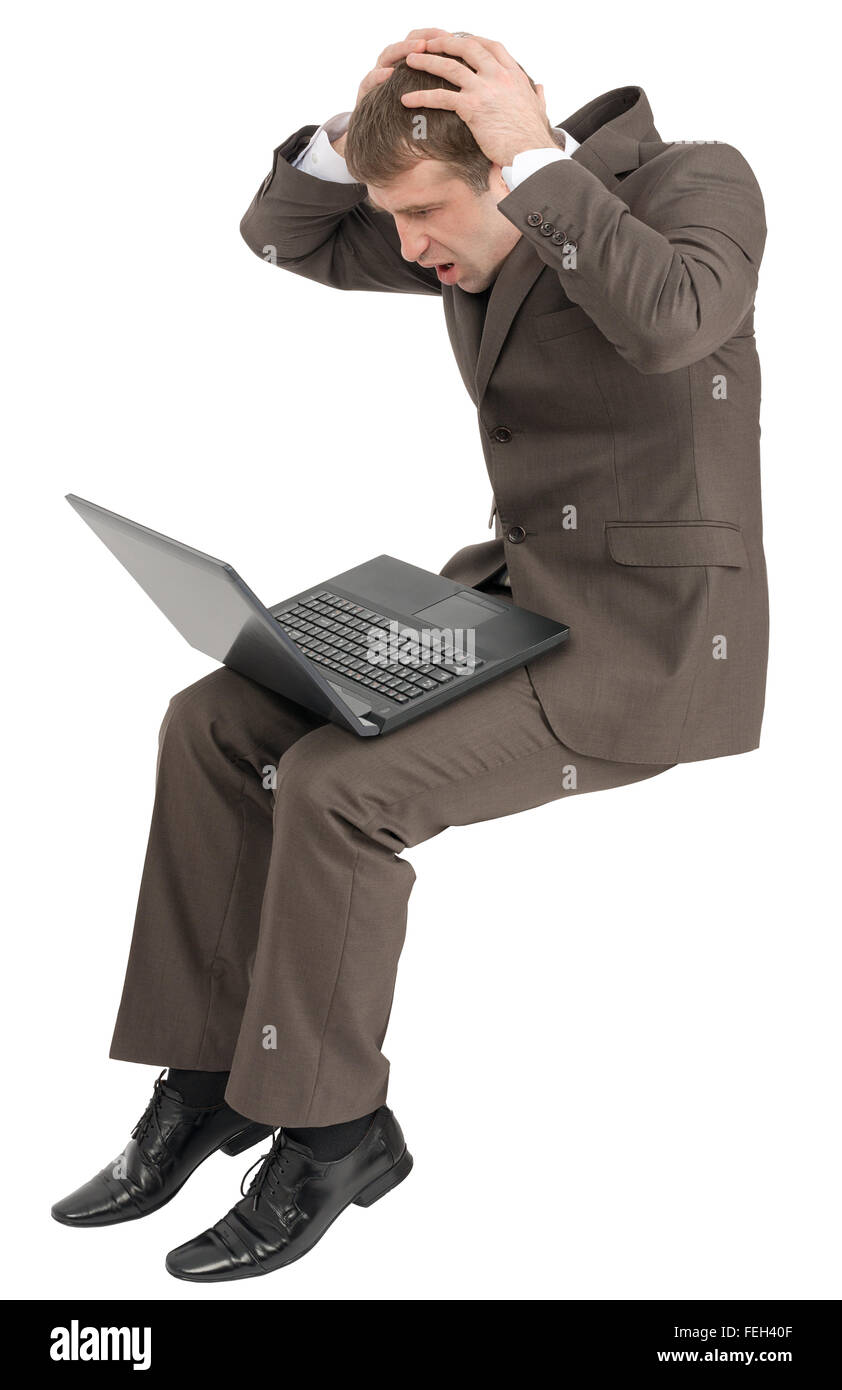 Confused businessman working on laptop Stock Photo - Alamy