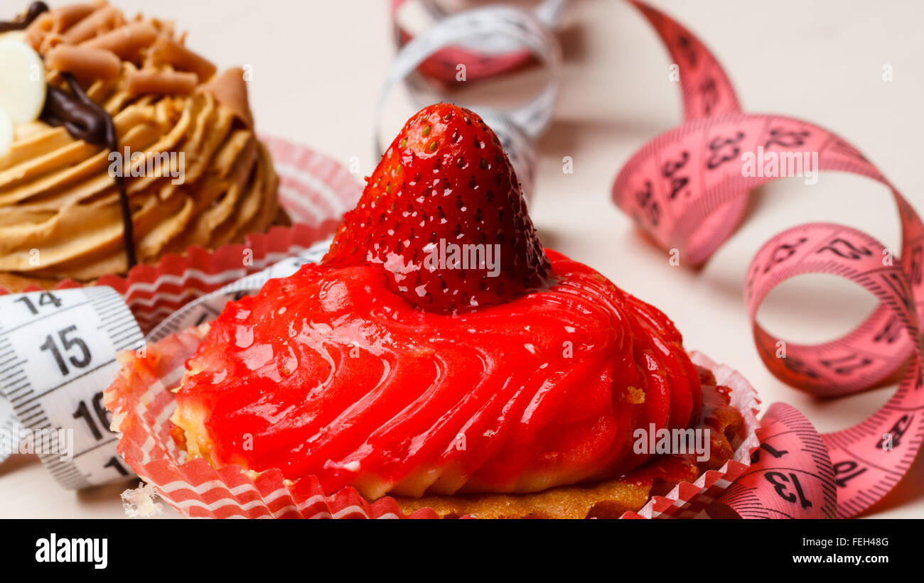 Appetite and gluttony concept. Fattening problem. Cakes cupcakes with ...