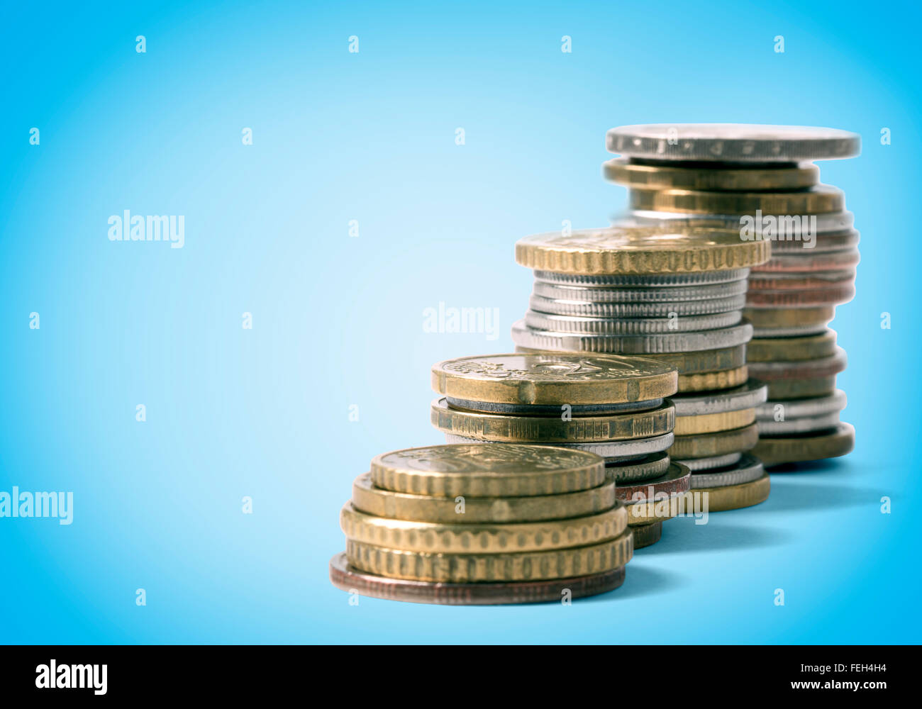 Stack of coins blue Stock Photo - Alamy