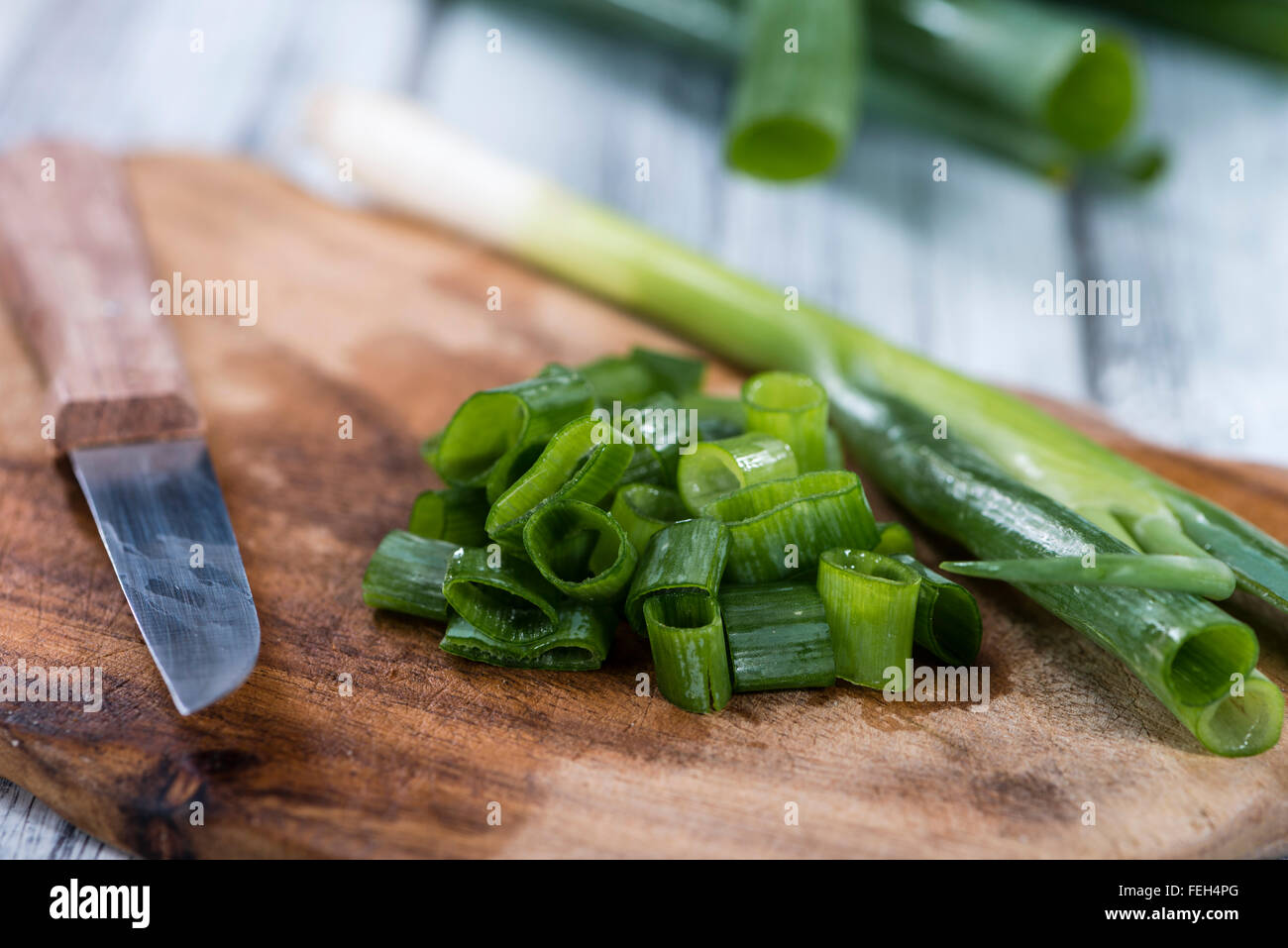 Portion of fresh Scallions (detailed close-up shot) on vintage wooden ...