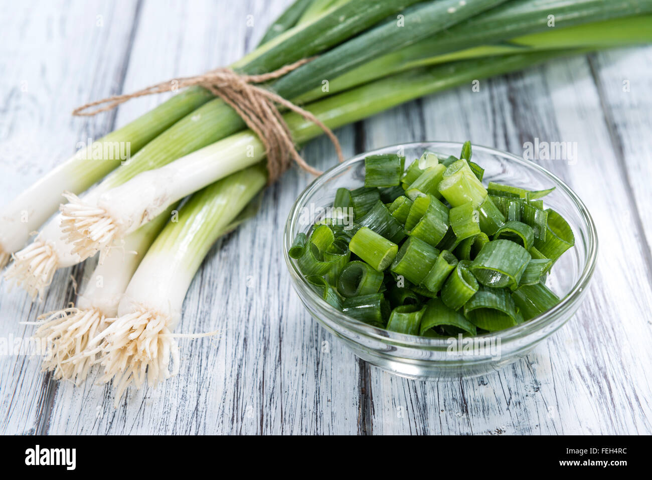 Scallions (fresh cutted) as close-up shot on wooden background Stock ...