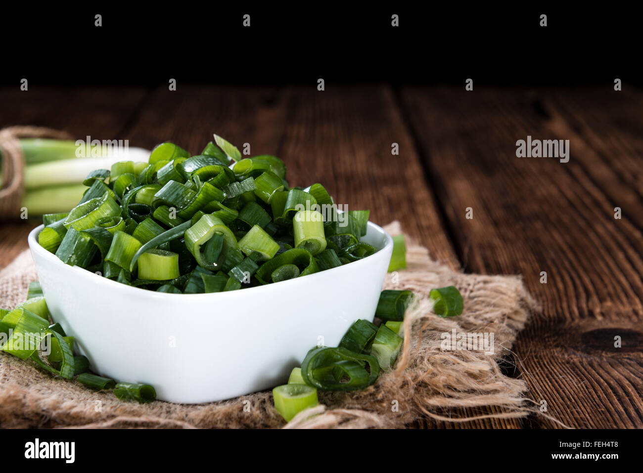 Portion of fresh Scallions (detailed close-up shot) on vintage wooden ...