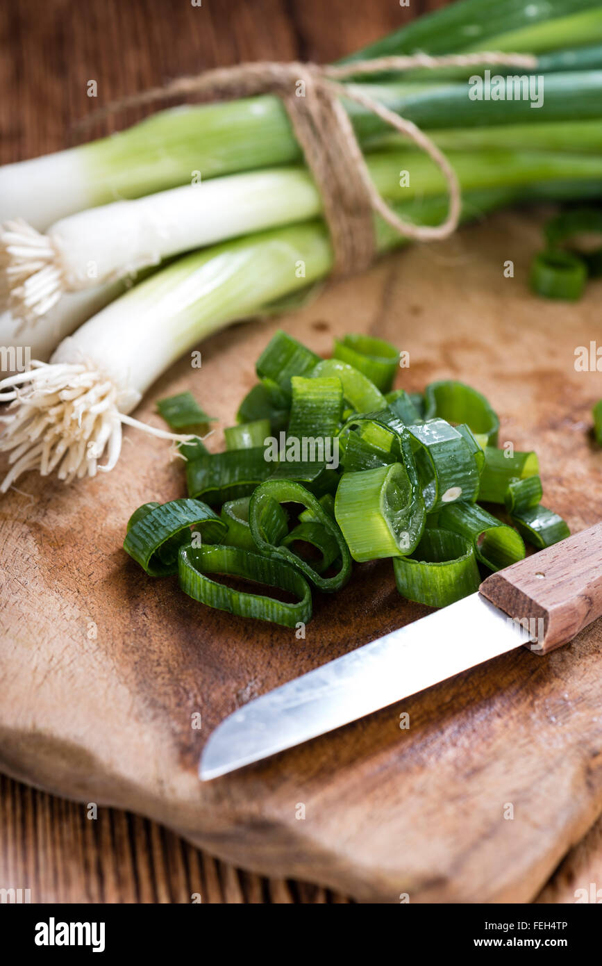 Portion of fresh Scallions (detailed close-up shot) on vintage wooden ...