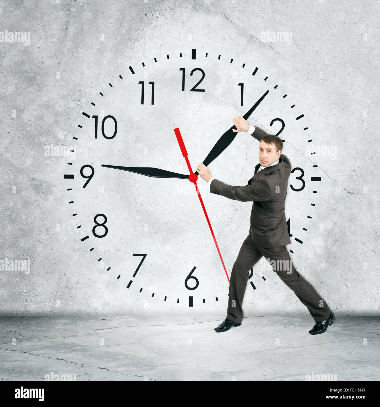 Businessman holding clock hand Stock Photo - Alamy