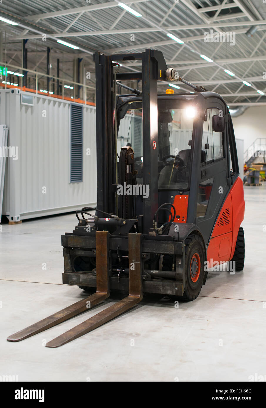 Orange forklift loader in the modern warehouse Stock Photo - Alamy