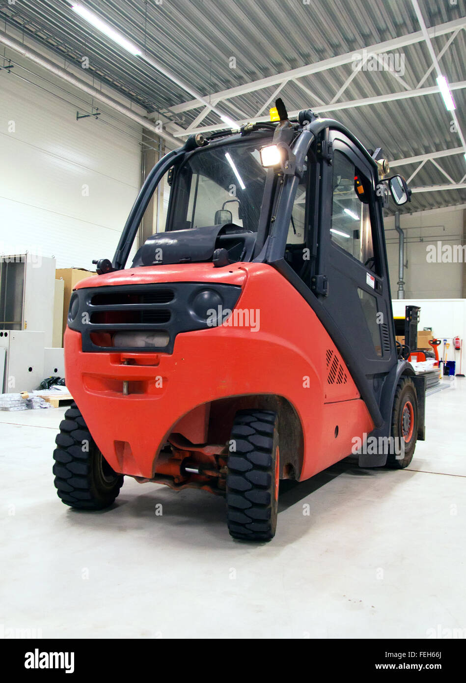 Orange forklift loader in the modern warehouse Stock Photo - Alamy