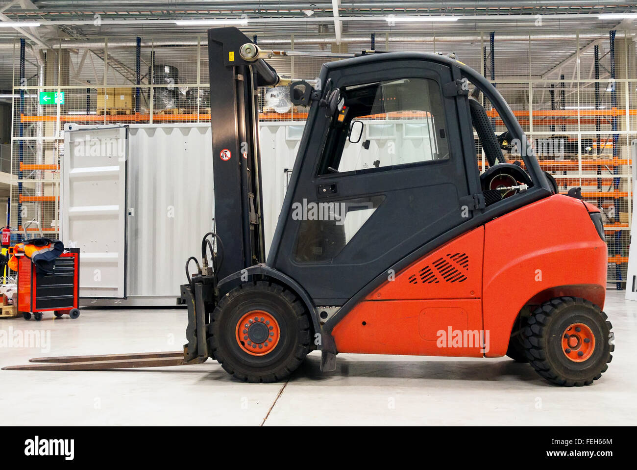 Orange forklift loader in the modern warehouse Stock Photo - Alamy