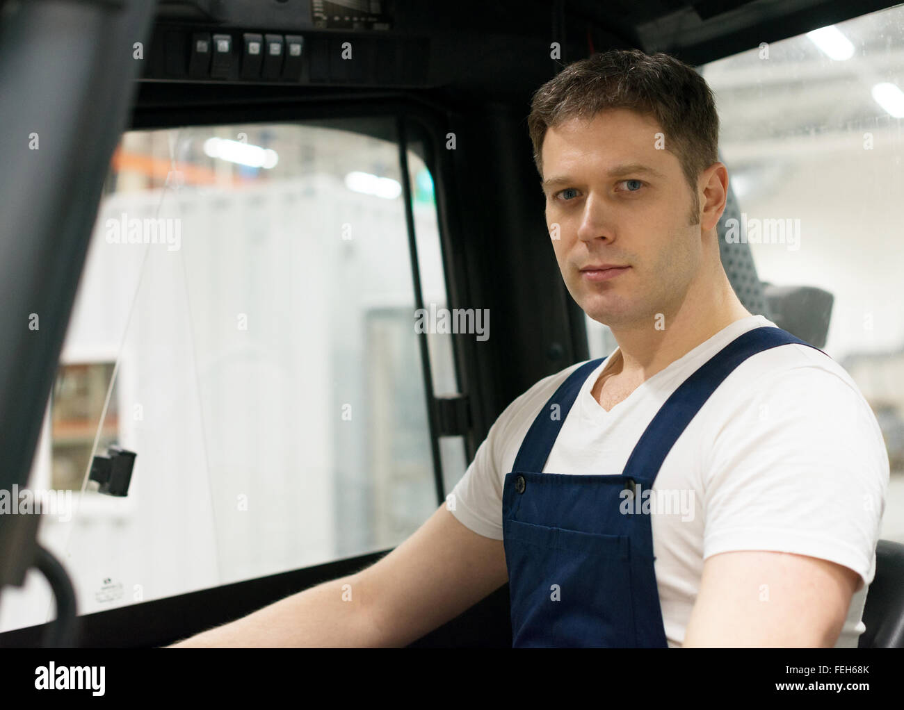 Forklift operator working in the warehouse Stock Photo - Alamy