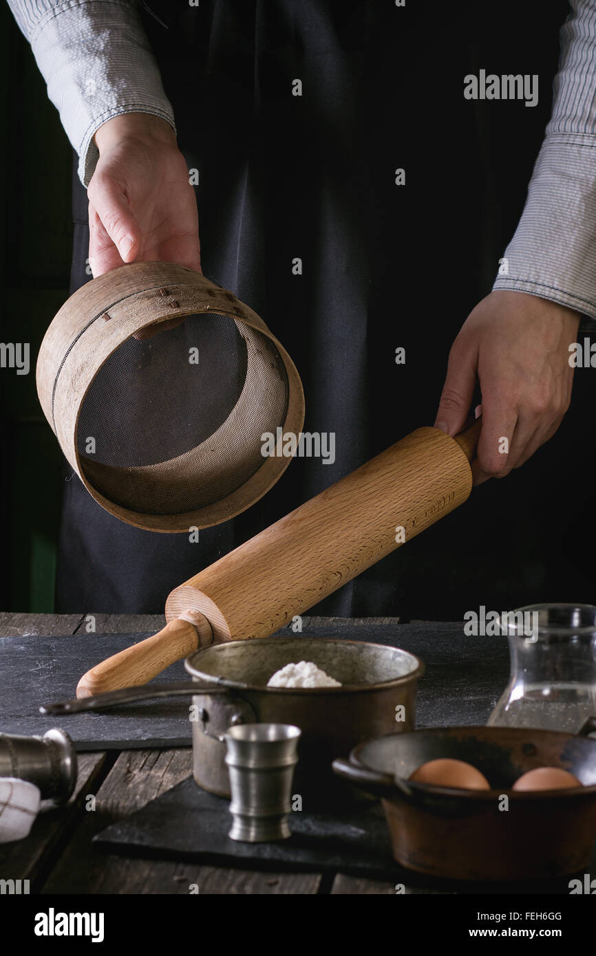 Female hands with wooden rolling-pin and sieve Stock Photo - Alamy