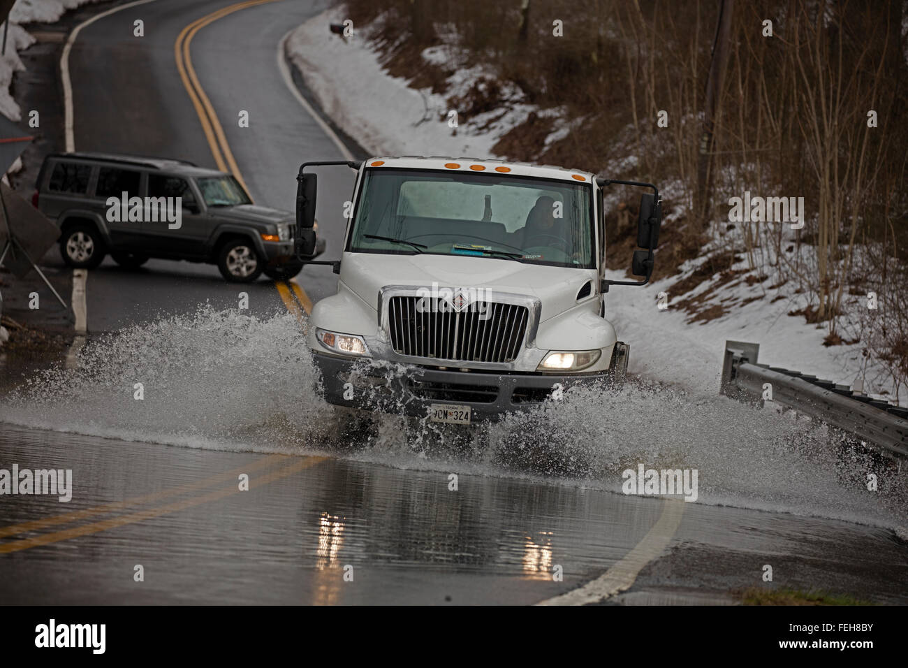 Truck driving down road Stock Photo - Alamy