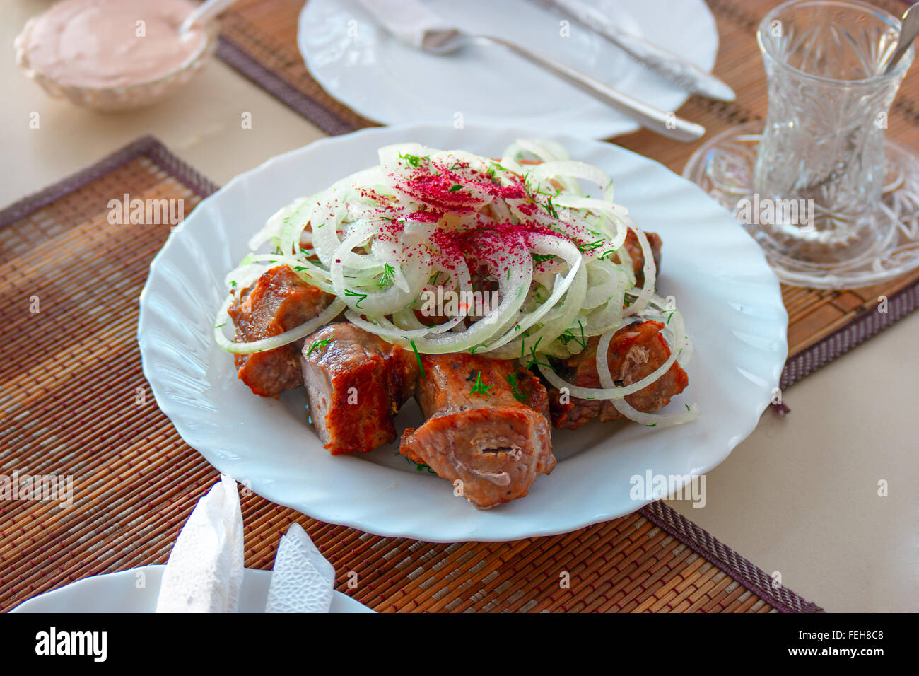 Traditional Turkish Shish Kebab on plate. Grilled meat and onion on top ...